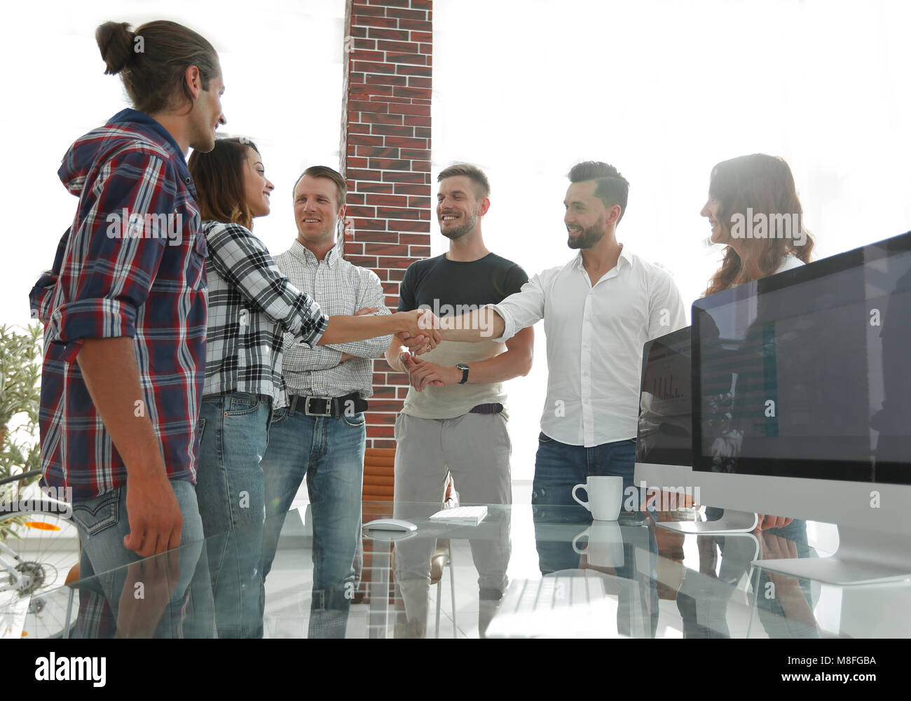 handshake partners in the creative office Stock Photo - Alamy
