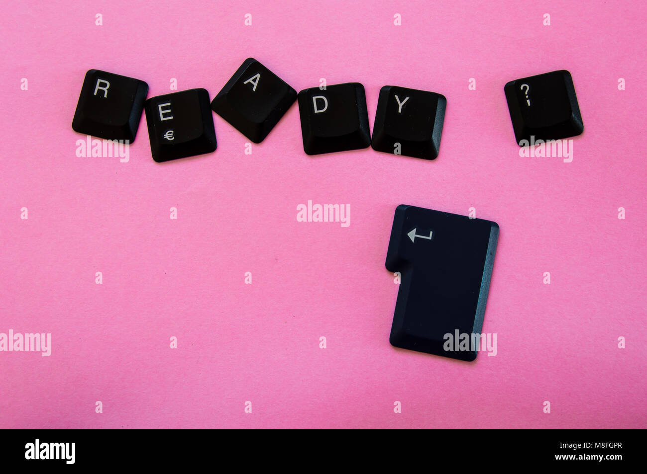 Black keys of a computer keyboard forming the phrase "Ready?" and a big ...