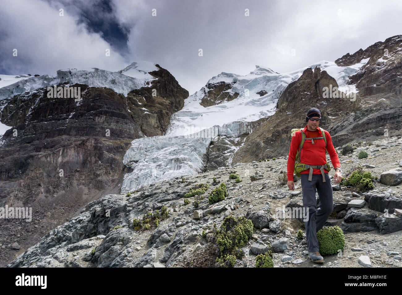 male mountain climber returns to a remote base camp in the Cordillera ...