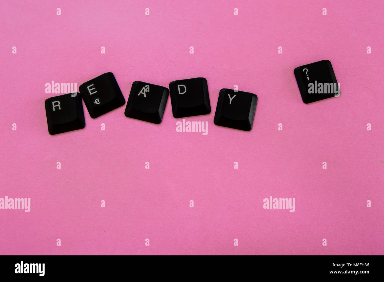 Black keys of a computer keyboard forming the phrase "Ready?" isolated ...