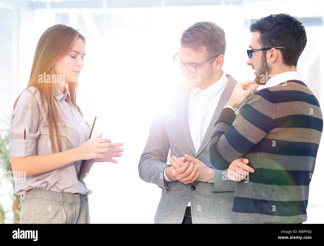 employees discussing working paper Stock Photo - Alamy