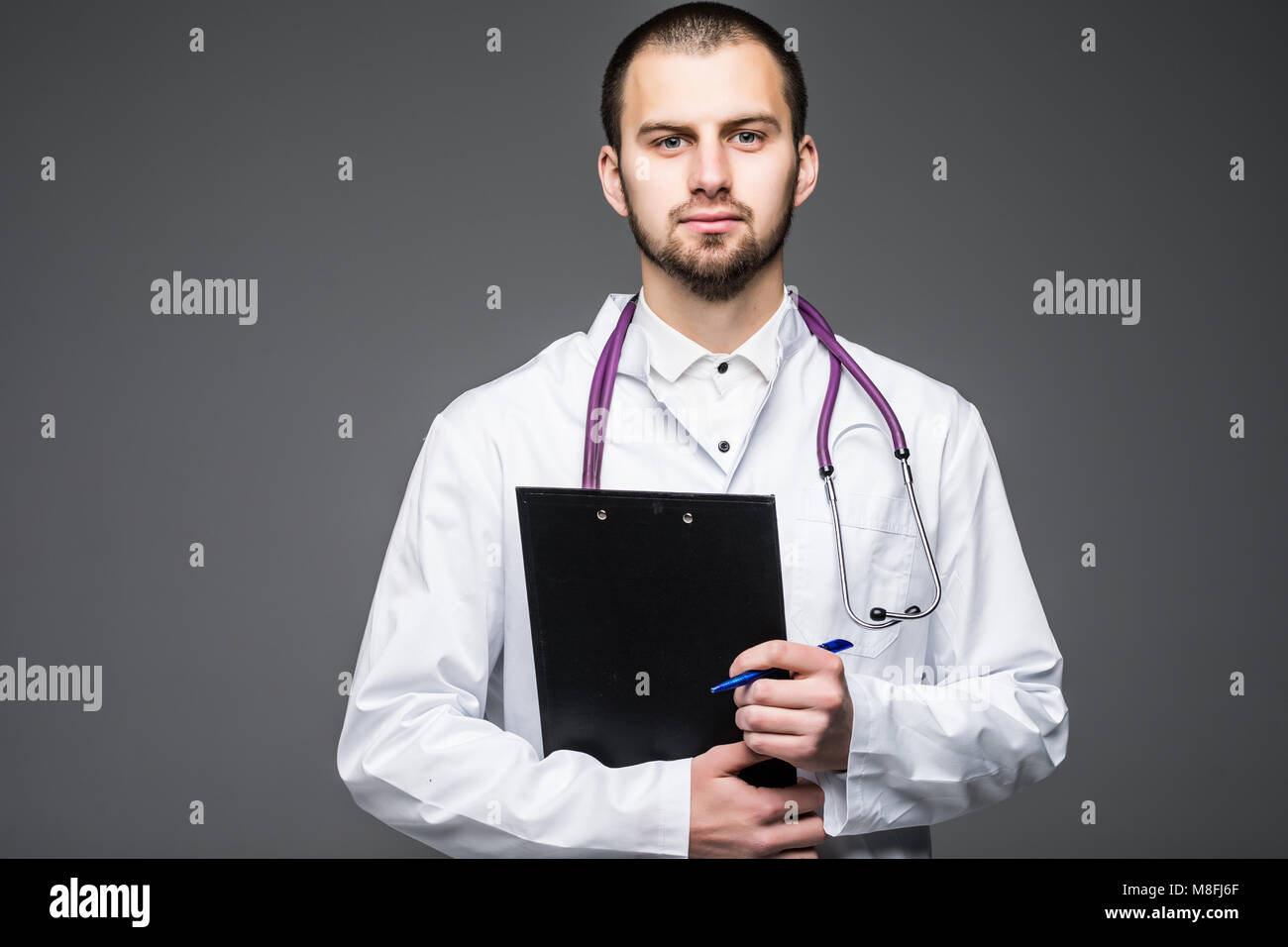 Smart male doctor wearing a medical suit hang on stethoscope and ...