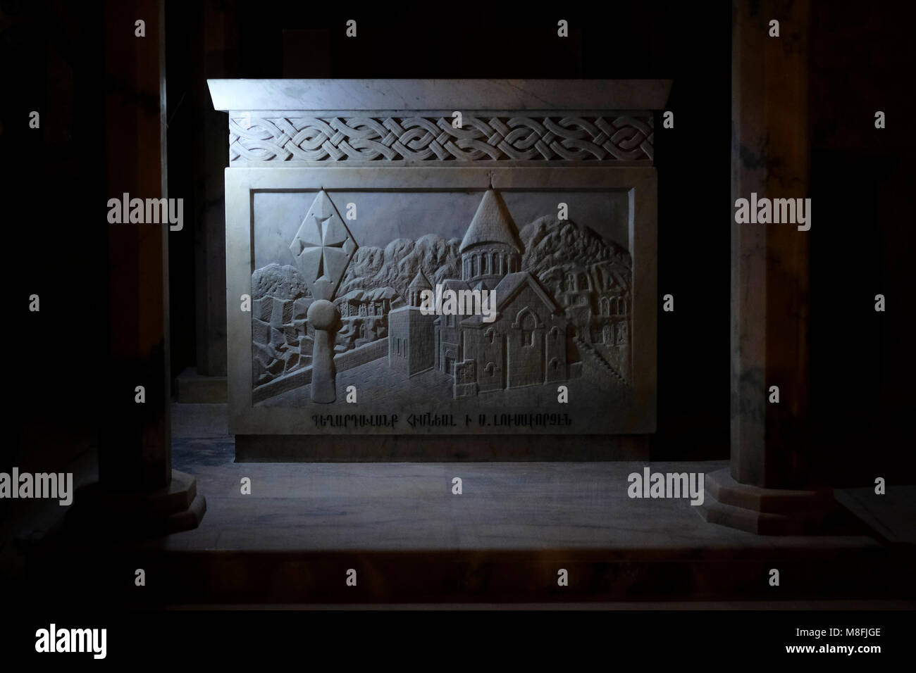 Carved image depicting the monastery of Geghard surrounded by towering ...