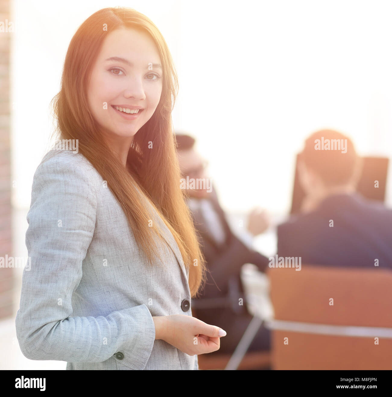 smiling employee on the background of the office Stock Photo - Alamy