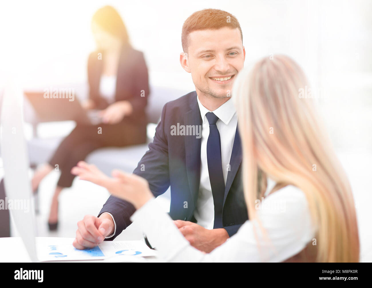 Manager talking with a colleague at the workplace Stock Photo - Alamy