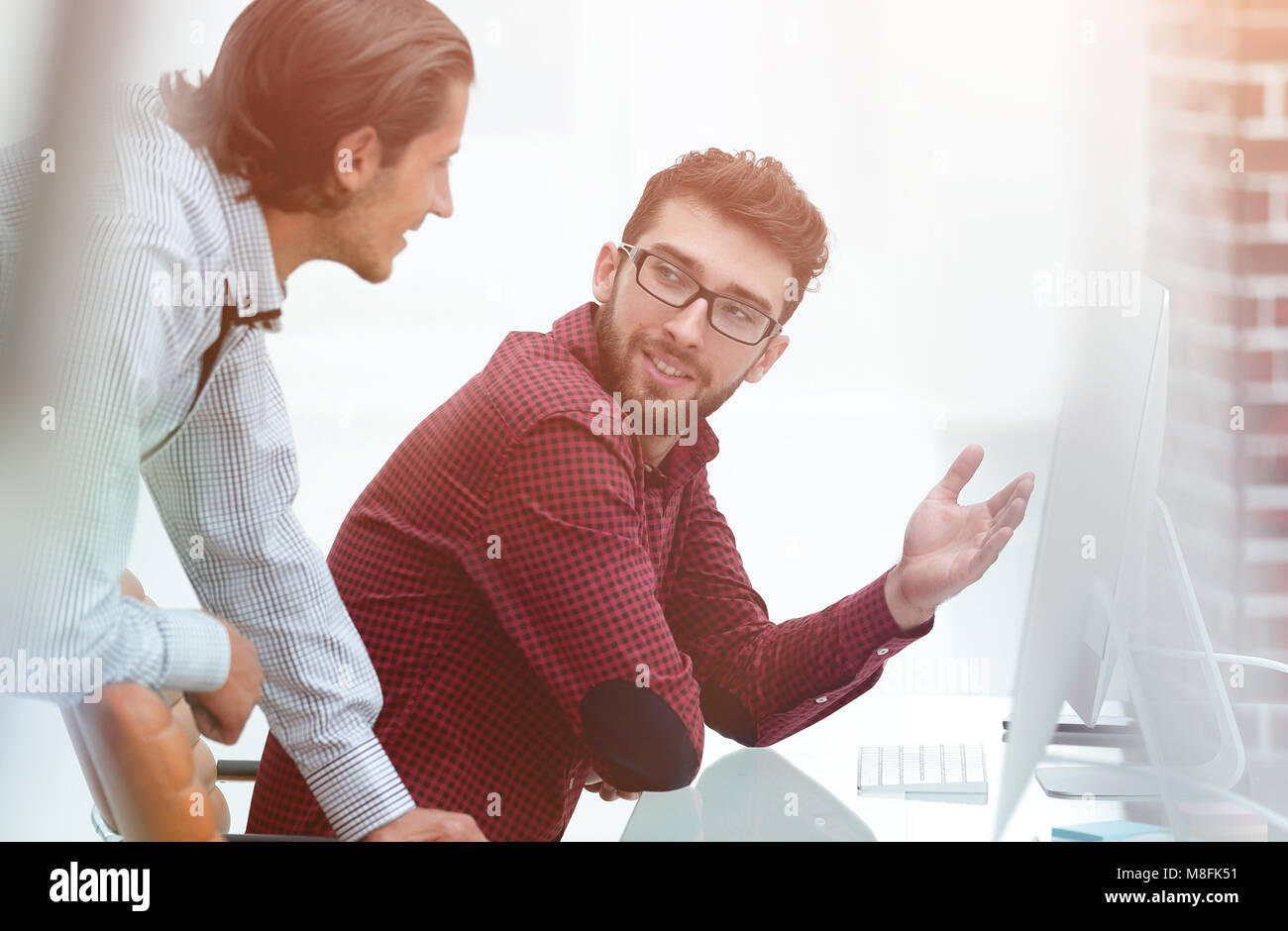 two office employee talking in the office Stock Photo - Alamy