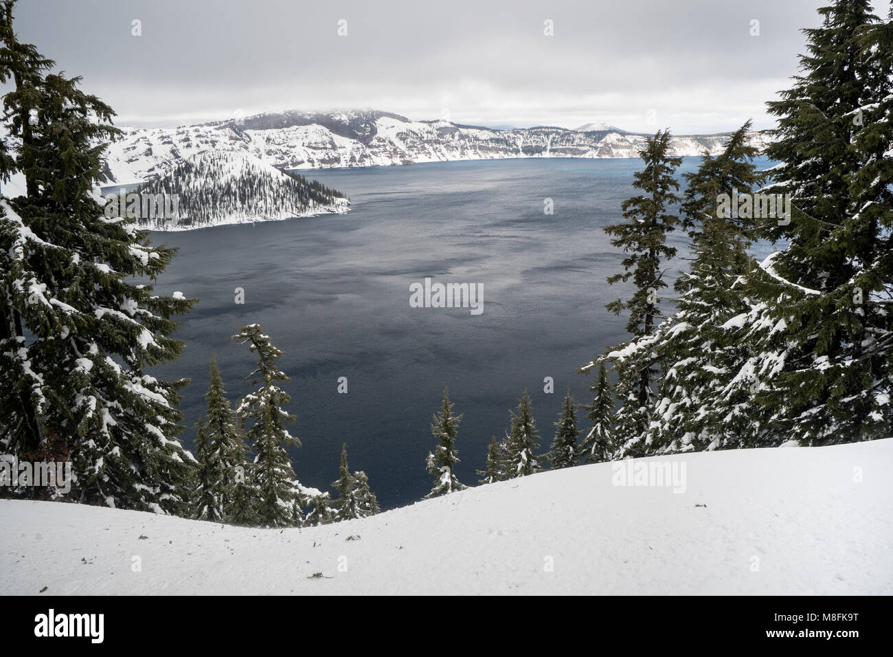 Clouds roll by the north rim at Crater Lake towards Mt Scott in the ...