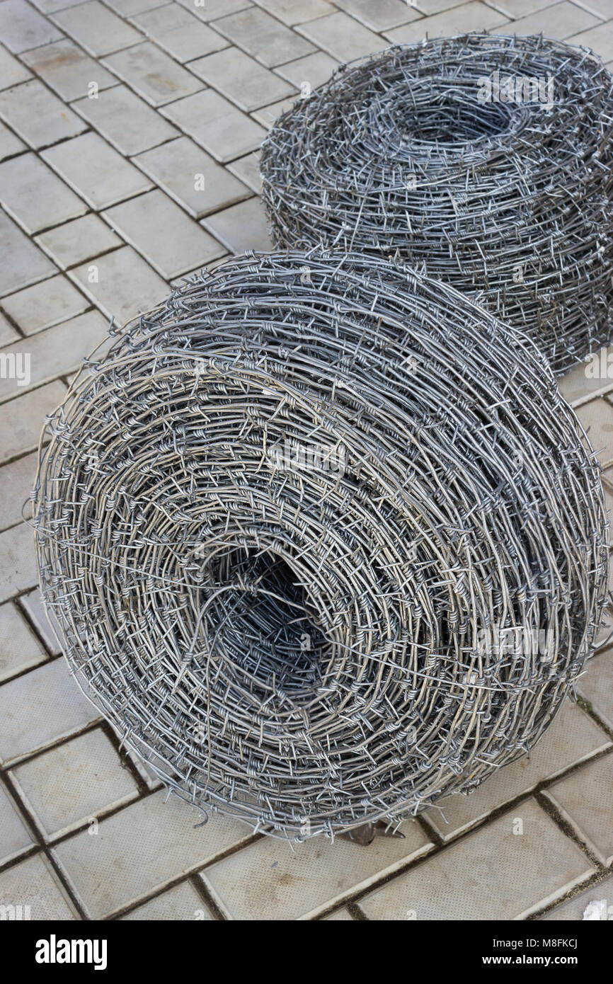 Two bays of barbed wire on the sidewalk Stock Photo - Alamy