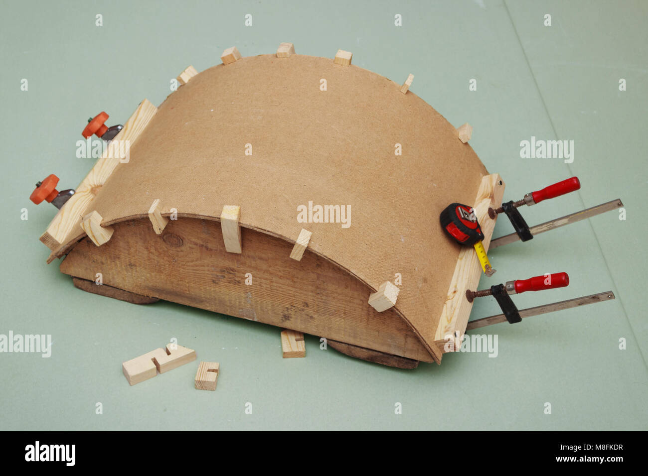 Gluing the arch of hardboard on a convex rule Stock Photo - Alamy