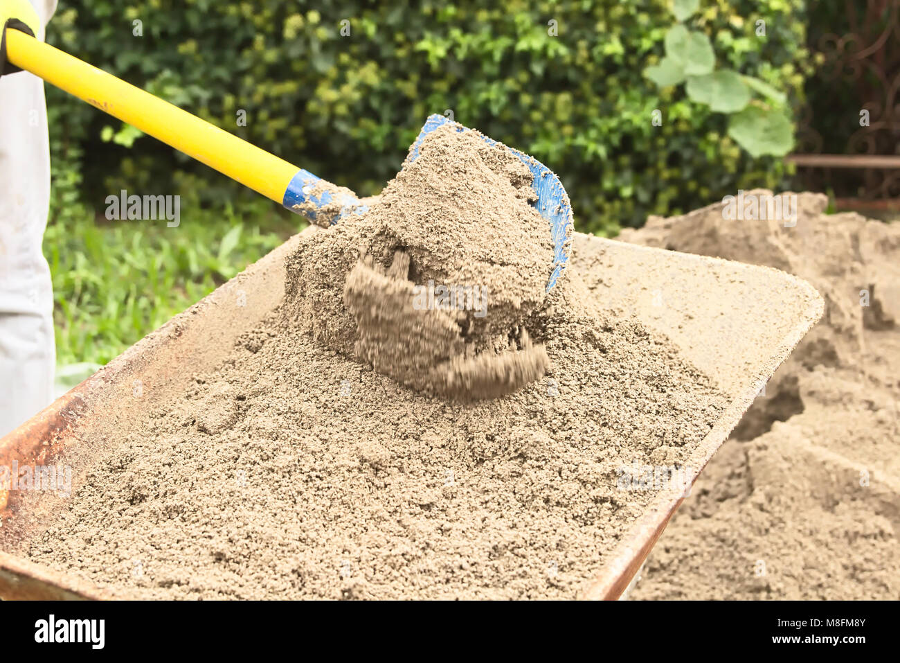 Picking up Sand with Shovel Stock Photo - Alamy