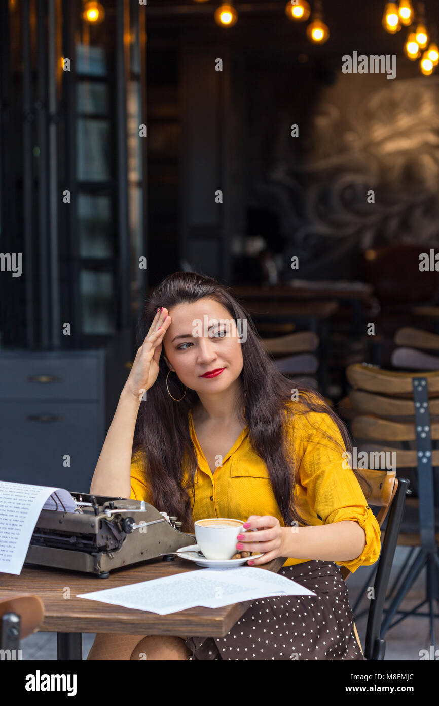 Writing and freelance concept. Female writer with long dark hair ...