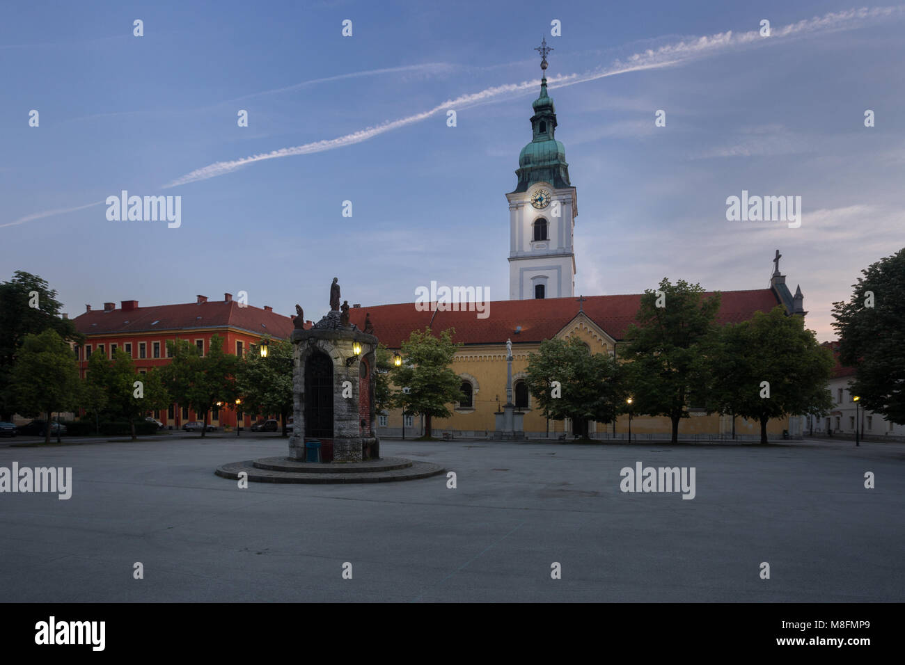 The church of The Holy Trinity and Franciscan monastery at sunset in ...