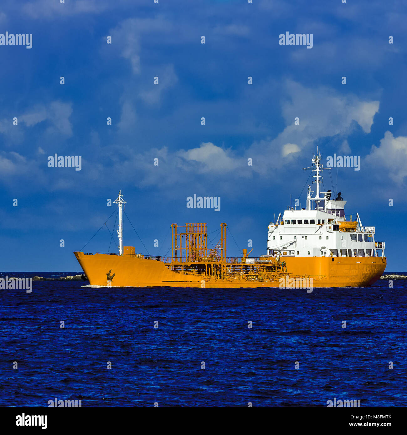 Yellow cargo tanker ship moving at the clear summer day Stock Photo - Alamy