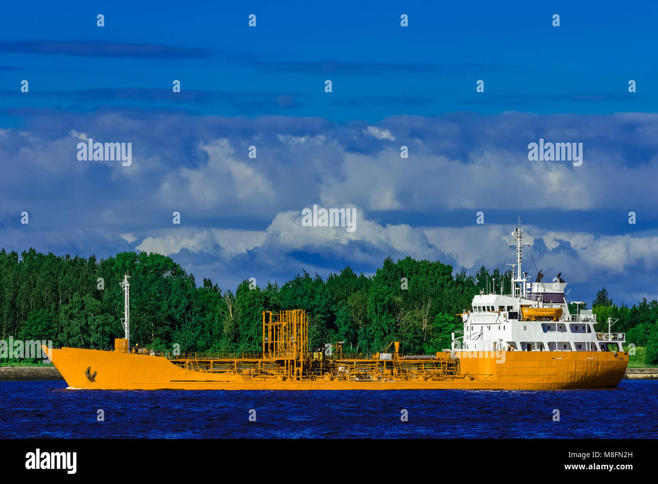 Yellow cargo tanker ship moving at the clear summer day Stock Photo - Alamy