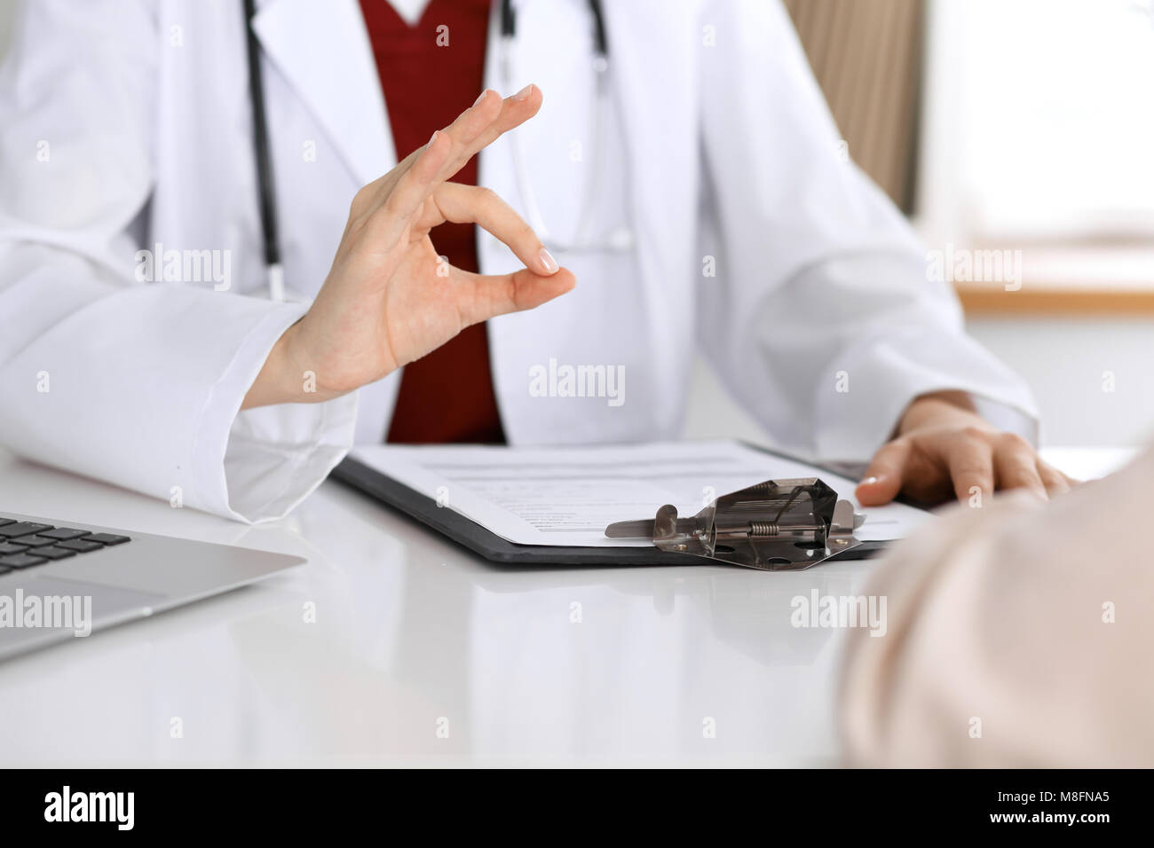 Close up of a doctor hand showing ok sign while phusician and his ...