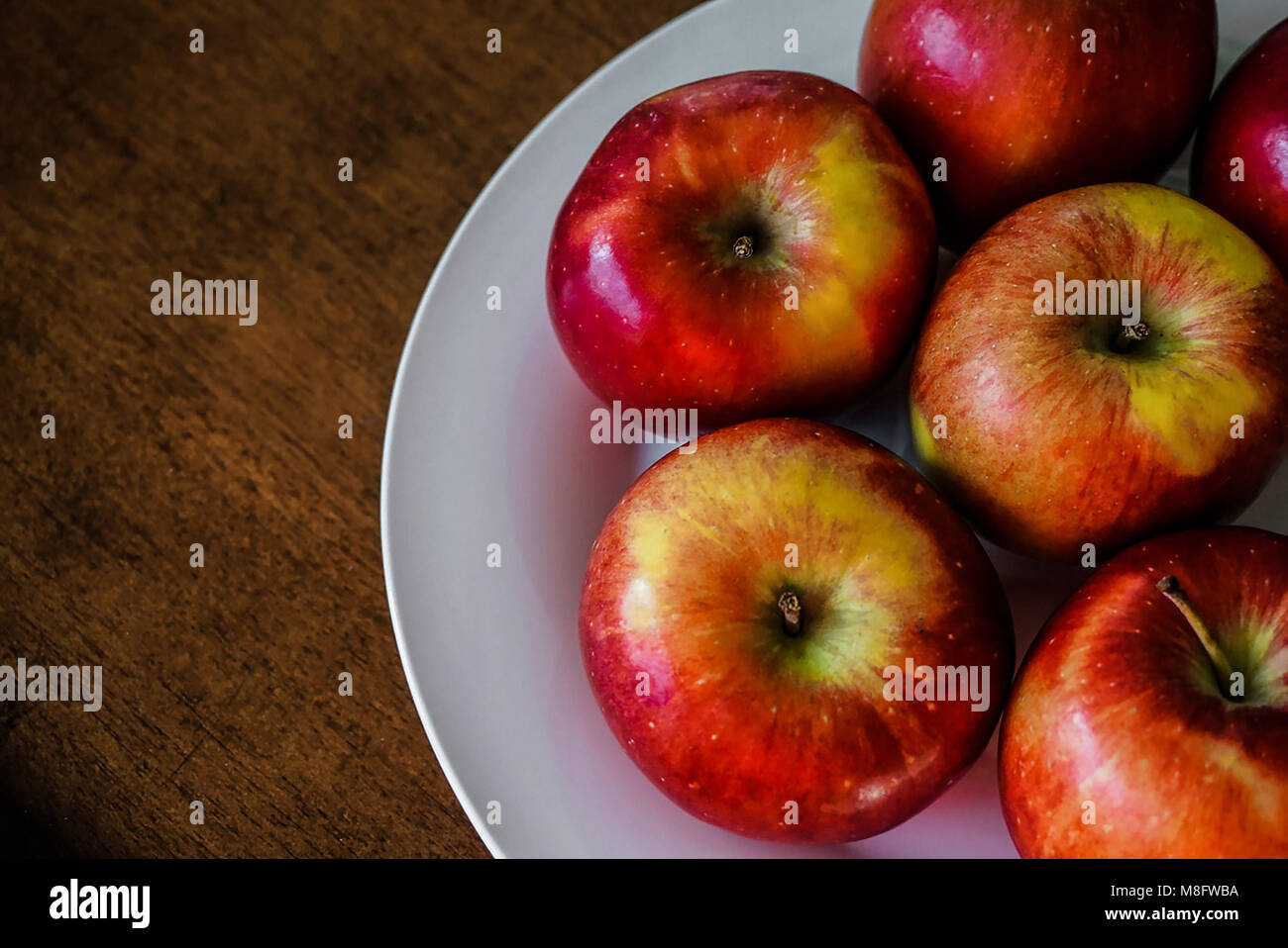 Crisp red apples on white plate Stock Photo - Alamy