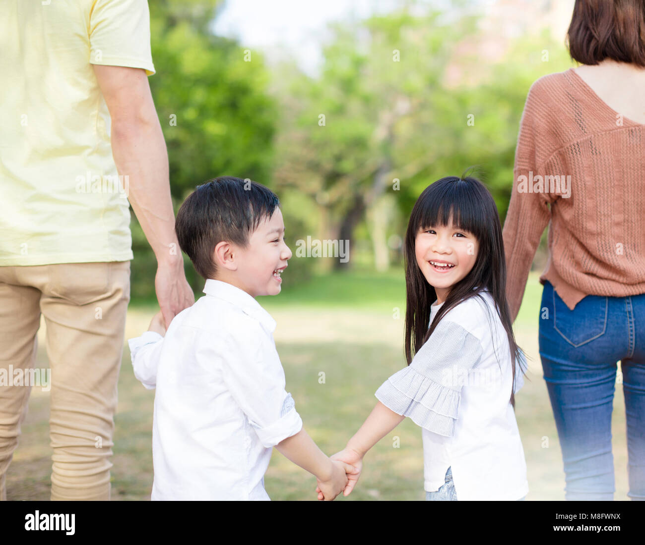 parent holds the hand of children Stock Photo - Alamy