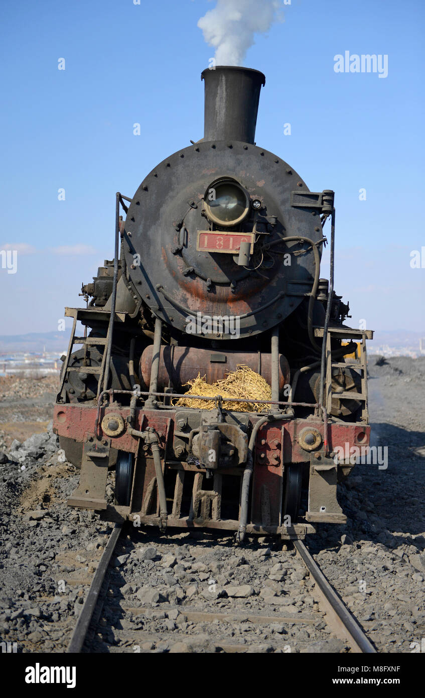 Locomotive of a spoil train at the tip in Fuxin. The coal mine system ...