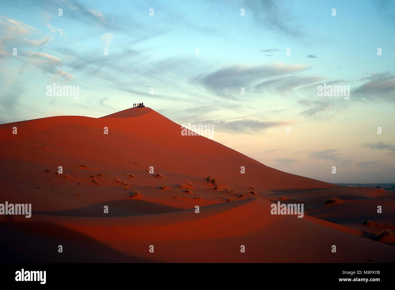 People on the top of dune in the morning in Sahara desert near Merzuga ...