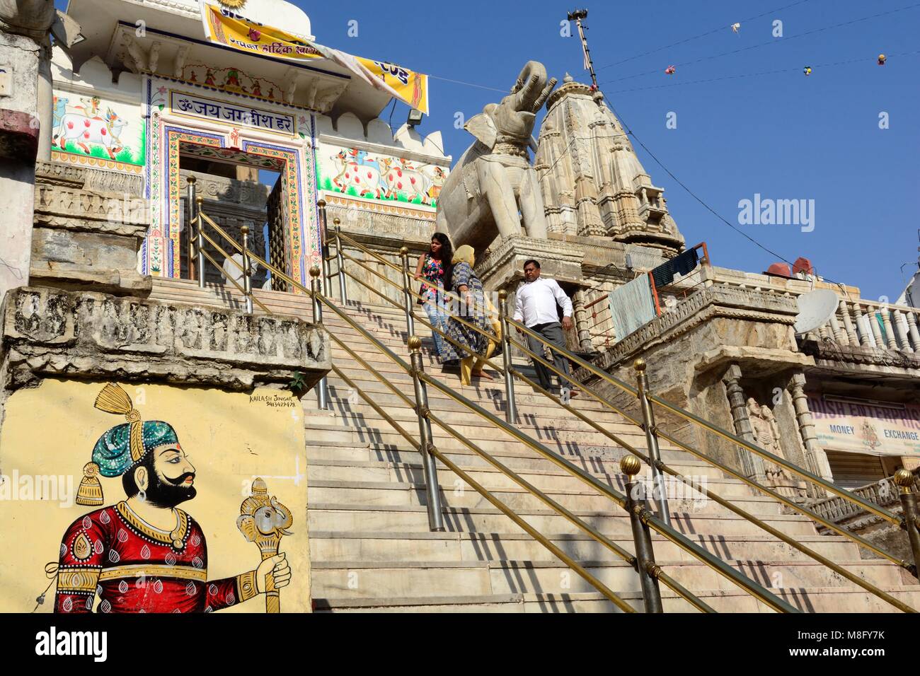 people walking down the steep steps of Jagdish Mandir Hindu Temple ...