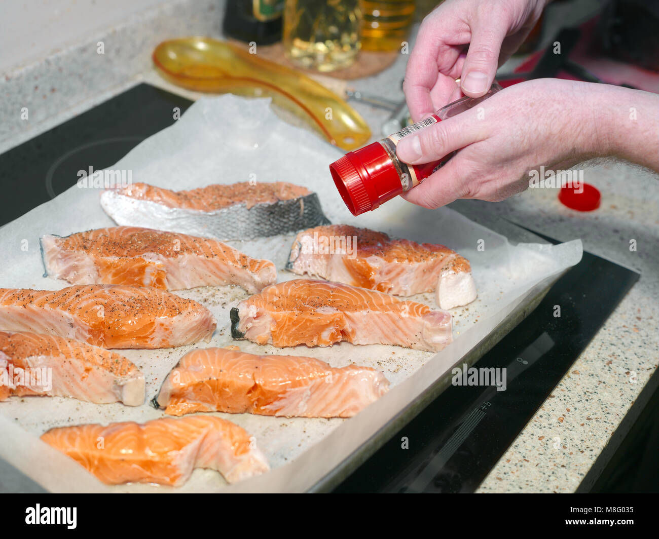 Hands with jar seasoning fish fillet ready to be cooked Stock Photo - Alamy