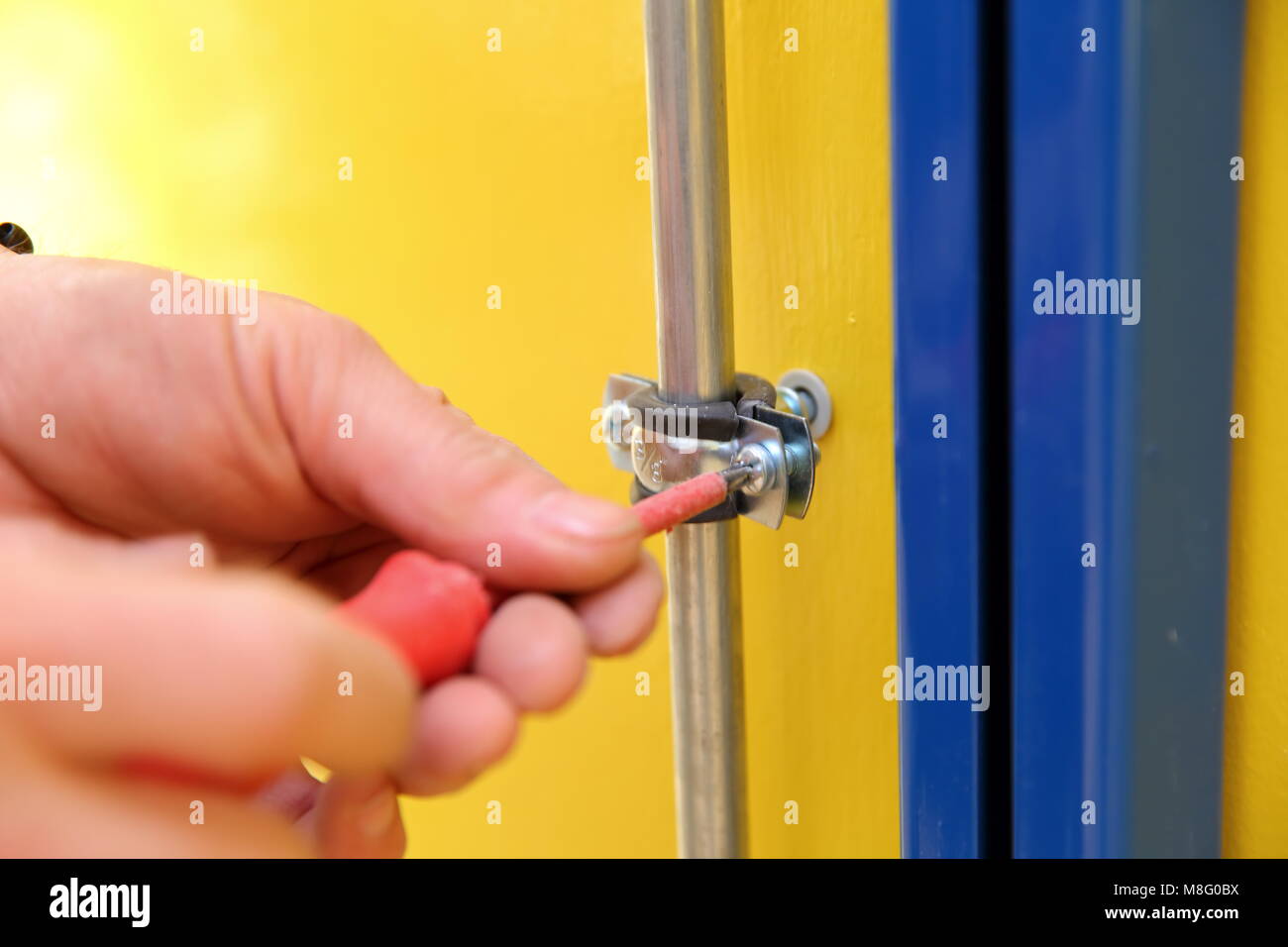 Mounting the handle to the central heating pipe Stock Photo - Alamy