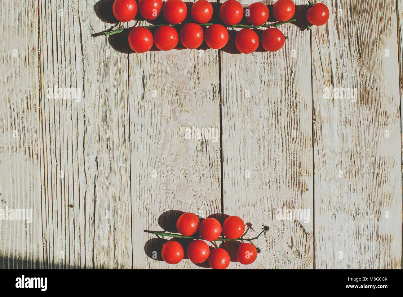 Cherry tomatoes on wooden table background with copy space, flat lay ...