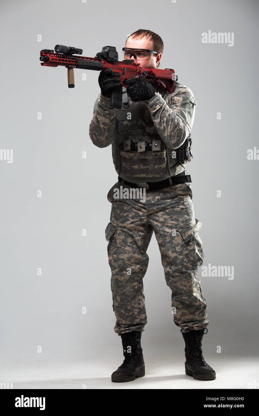 Full-length picture of aiming military man in helmet with gun Stock ...