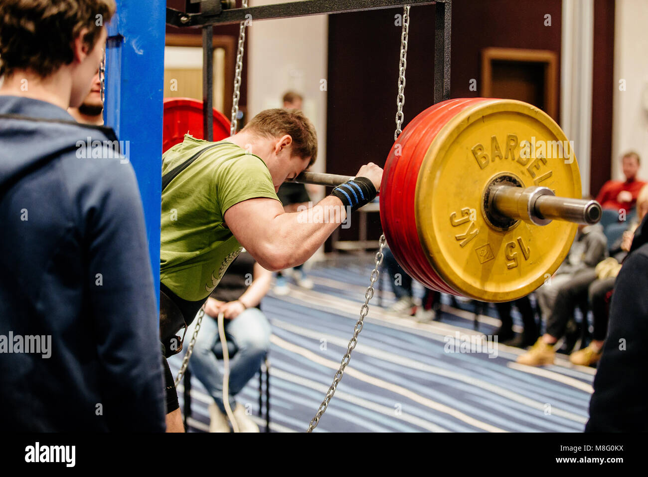 powerlifter prepares squat with barbell during Open championship of ...