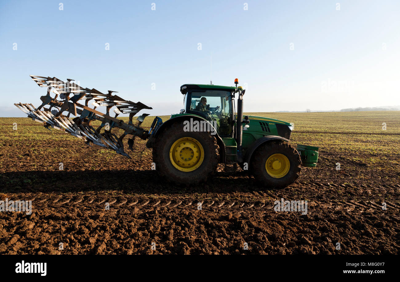 A farmer ploughing a field Stock Photo - Alamy