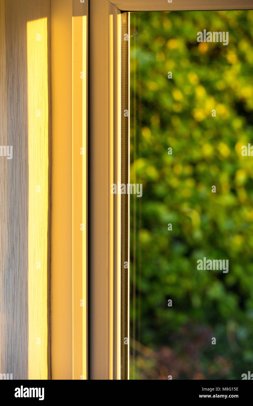 Warm evening light on a PVC double glazed window Stock Photo - Alamy