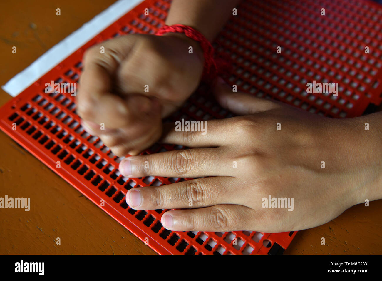 Agartala, India. 14th Mar, 2018. Indian blind girls are writing in a ...