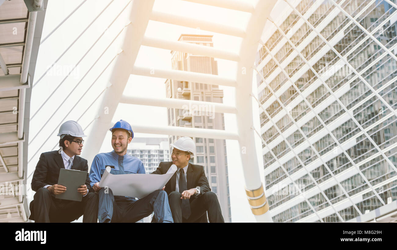 cheerful young engineers discussing the project business of the ...