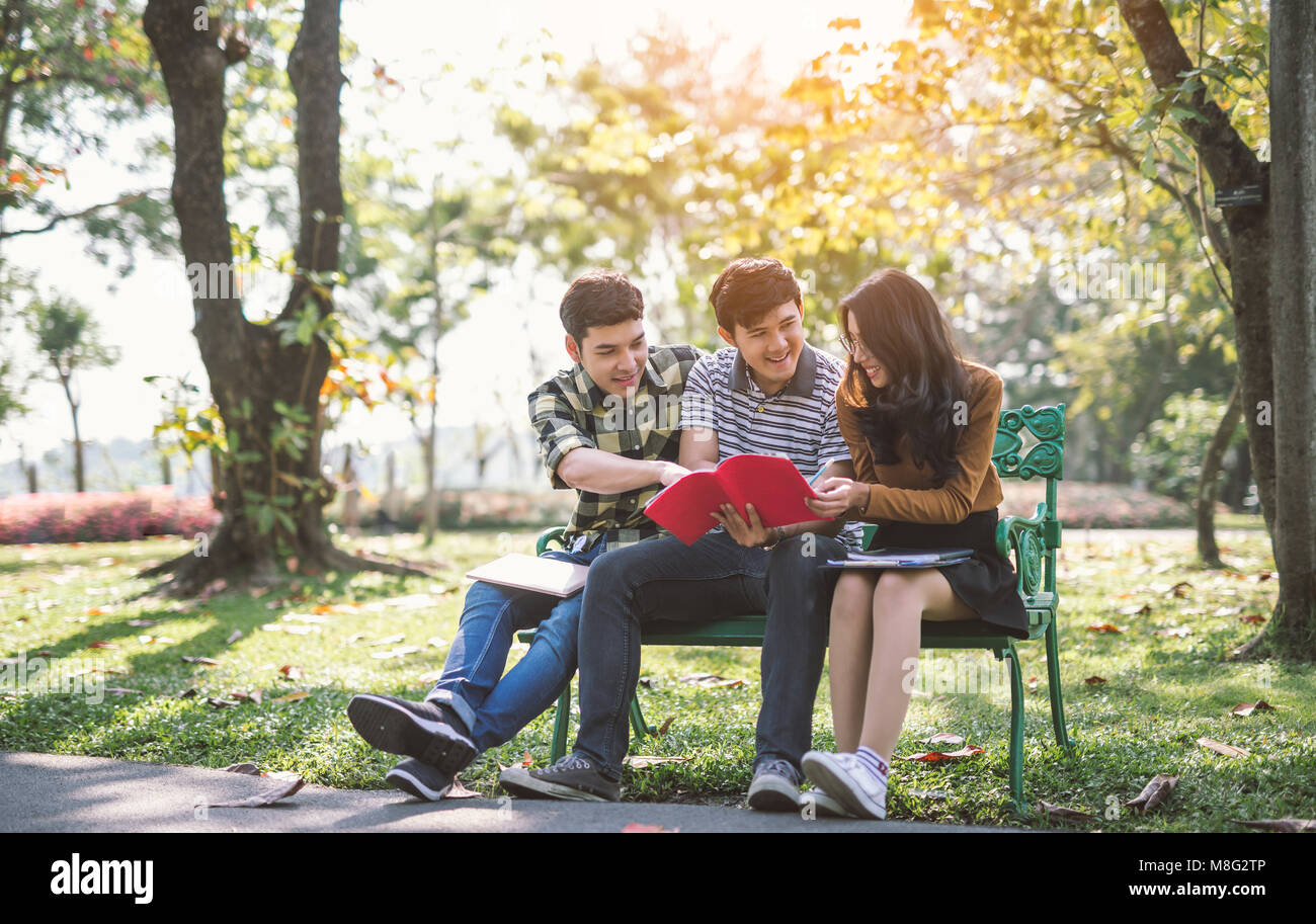 Young people studying reading book in park. education study by read ...