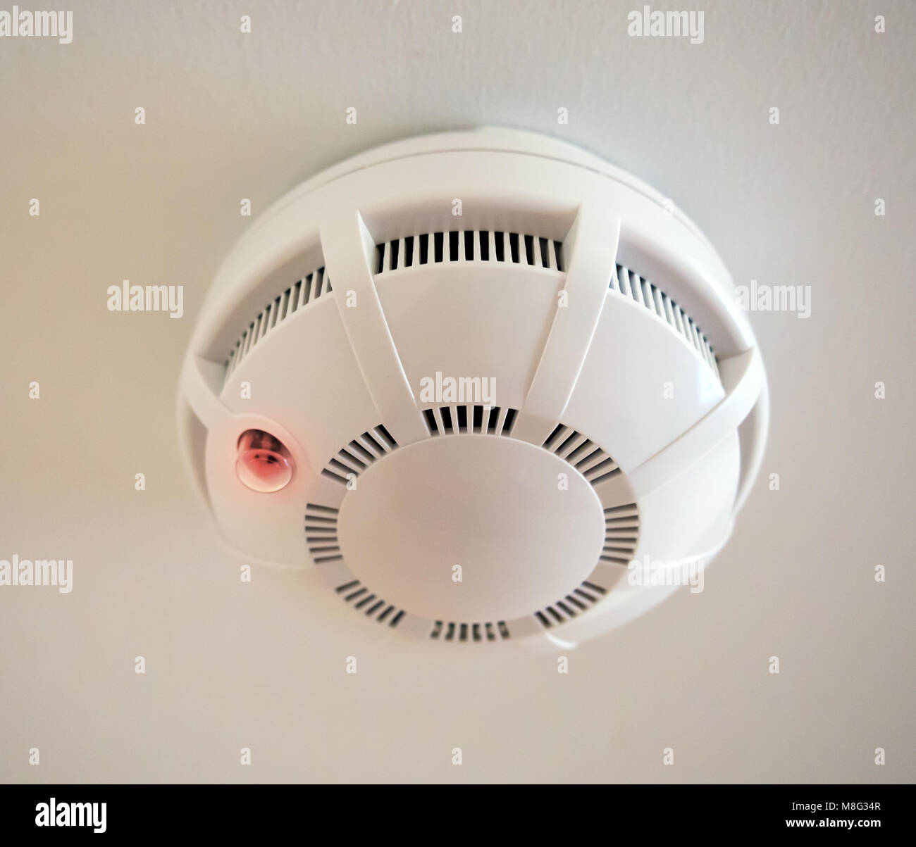 The fire alarm sensor installed on the ceiling Stock Photo - Alamy