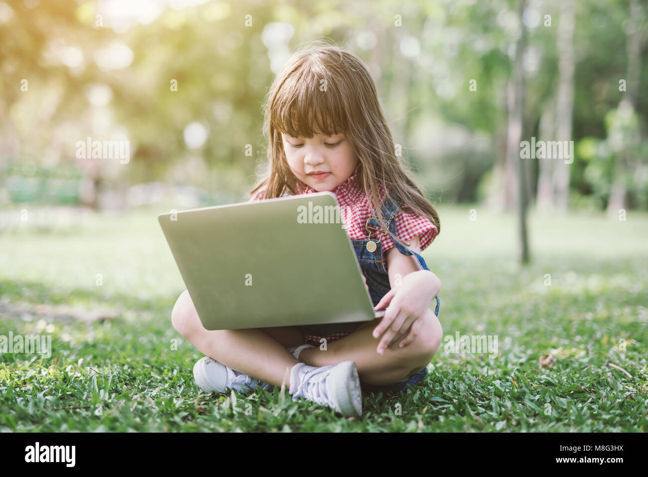 little girl with laptop. happy children in nature technology education ... little girl with laptop. happy children in nature technology education ...