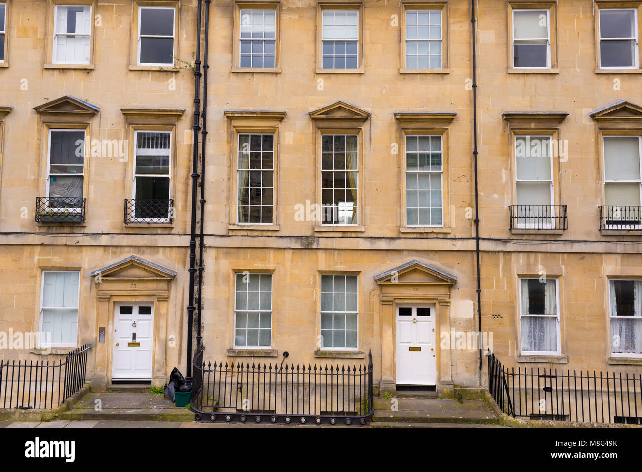 Facade of Georgian residential building made from the local, golden ...