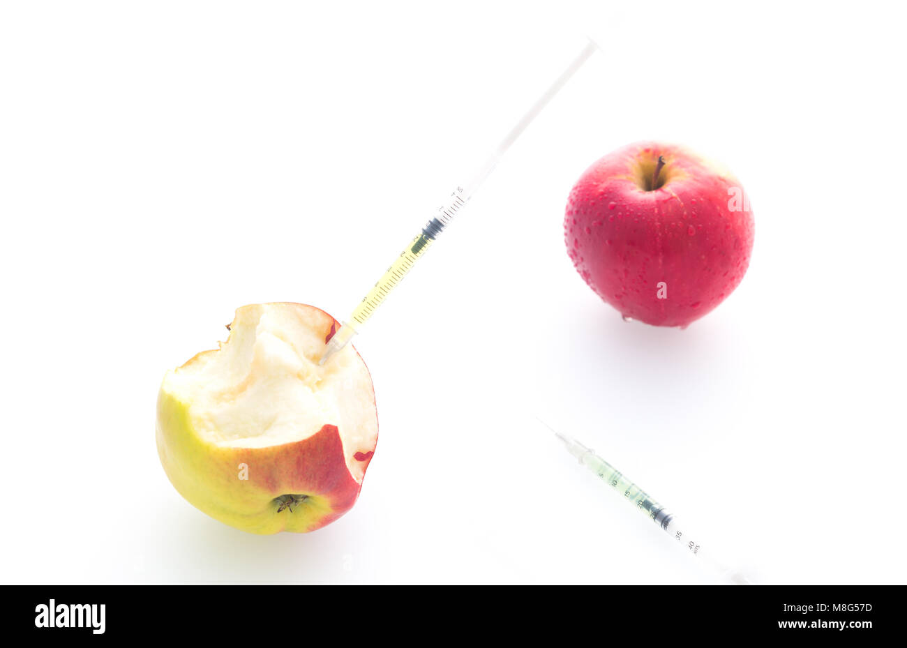 Apple with punched needles and syringes as a concept for modifying food ...
