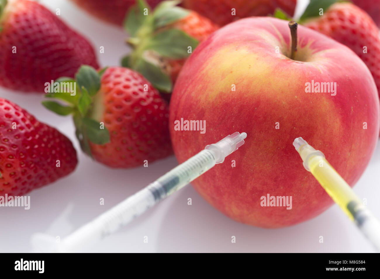 Modified food, fruits,apple and strawberries with punched needles and ...