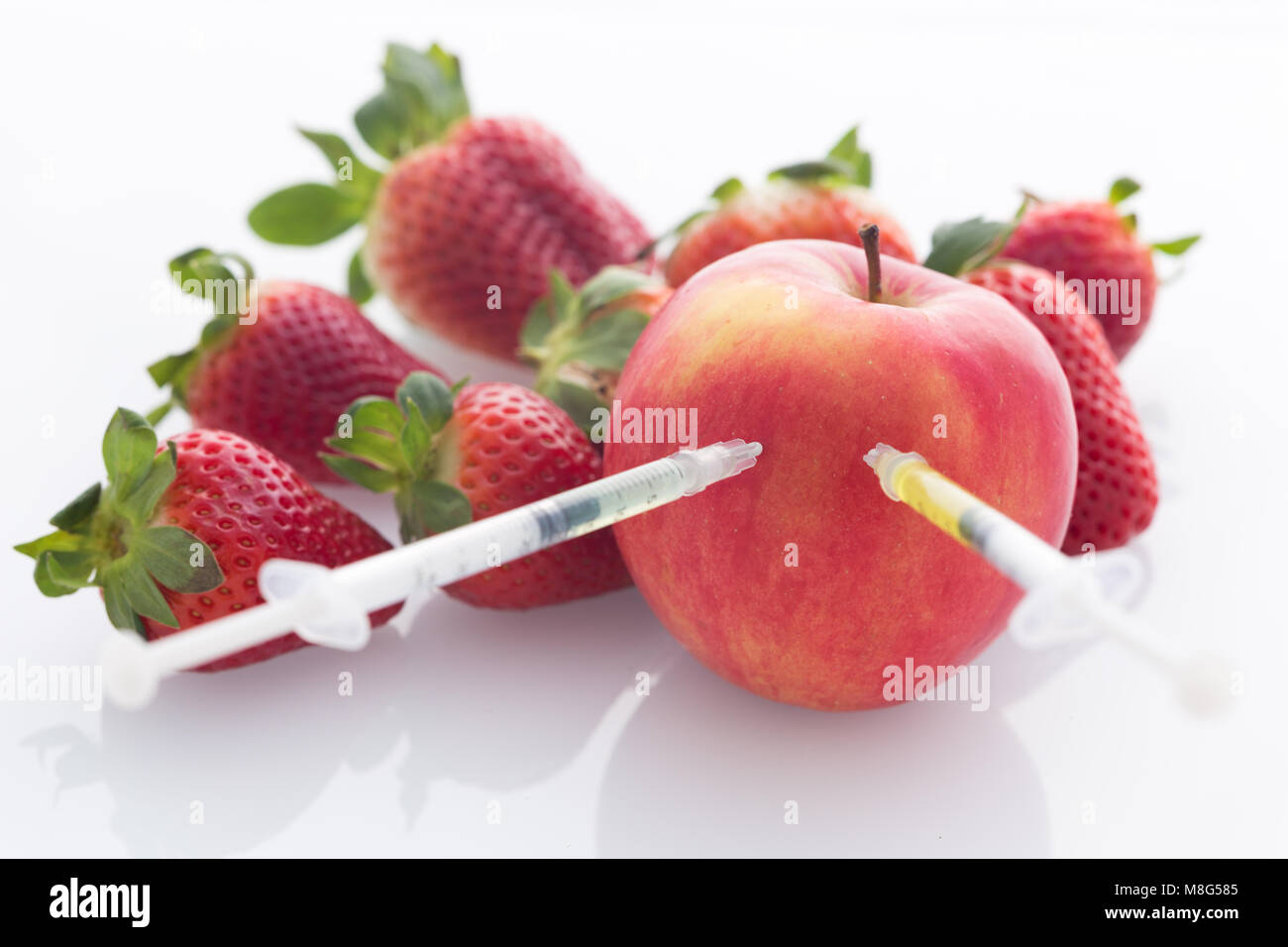Modified food, fruits,apple and strawberries with punched needles and ...