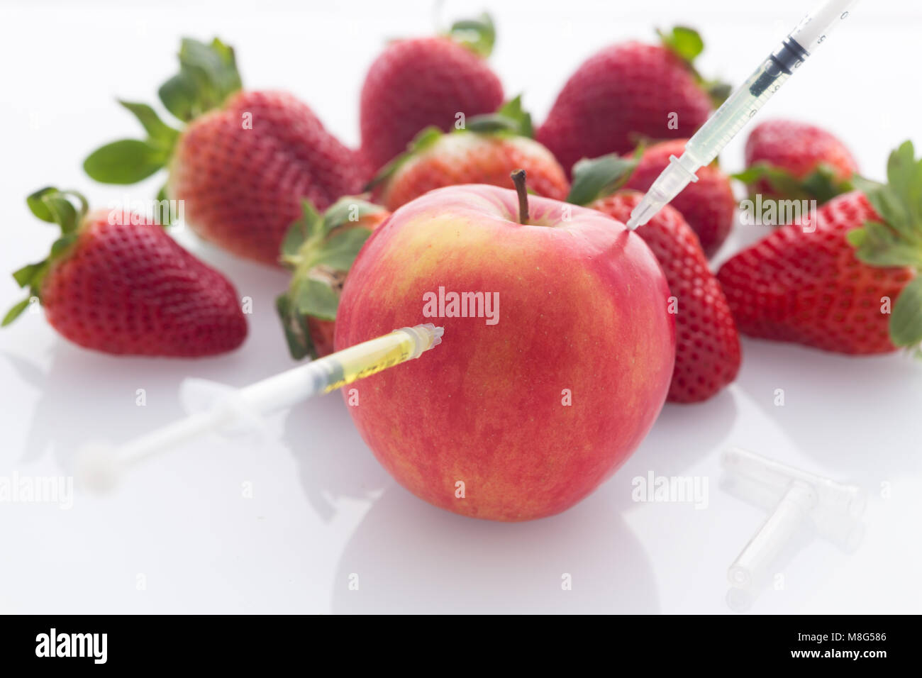 Modified food, fruits,apple and strawberries with punched needles and ...