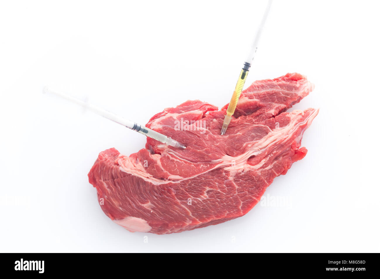 Modified food. Beef meat with embedded syringes / concept Stock Photo ...