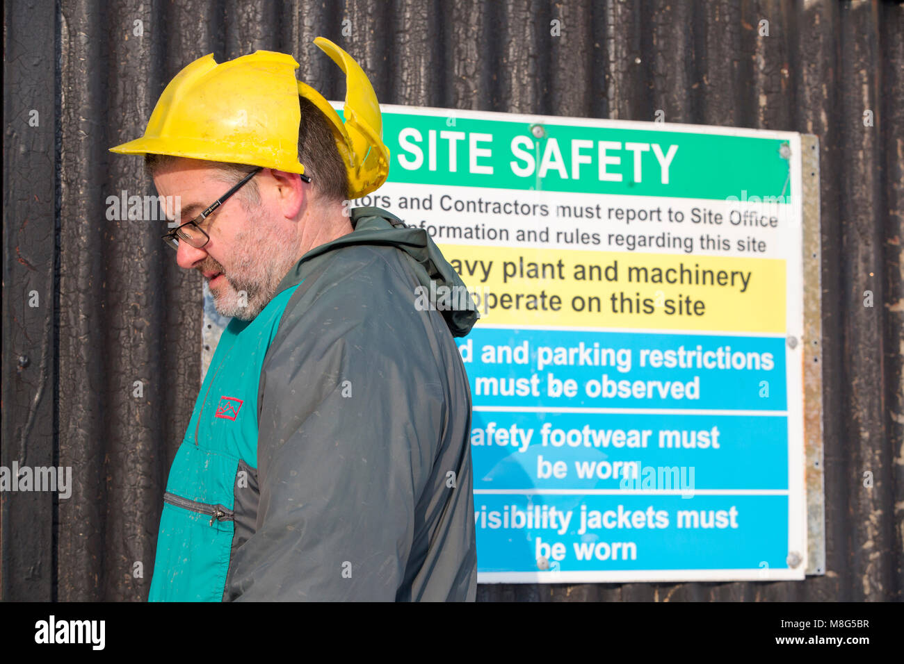 A man wearing a shattered hard hat Stock Photo - Alamy