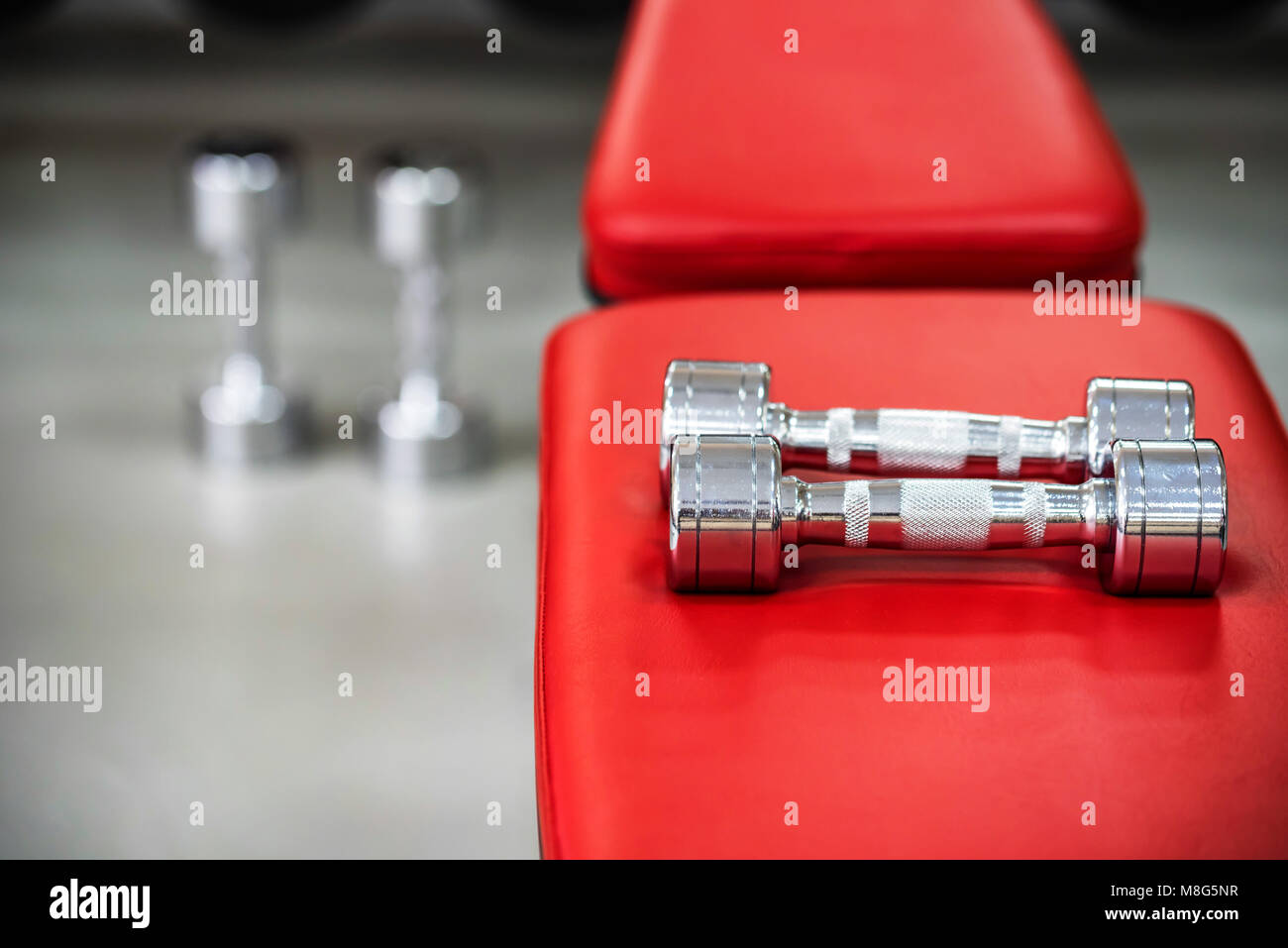 Pair of silver dumbbells in gym Stock Photo - Alamy