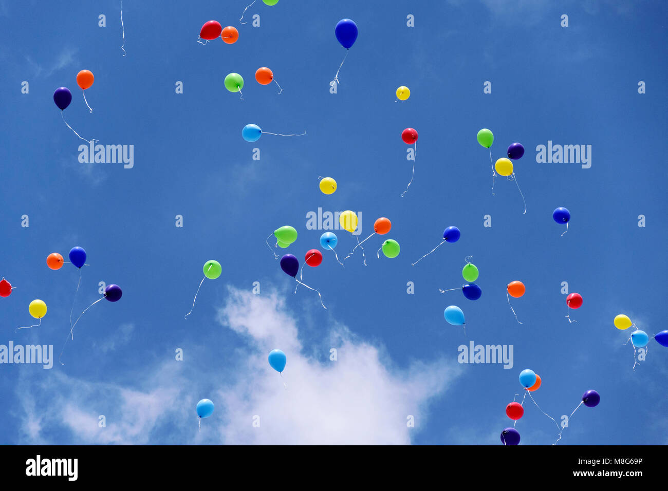 Balloons flying to the blue sky Stock Photo - Alamy