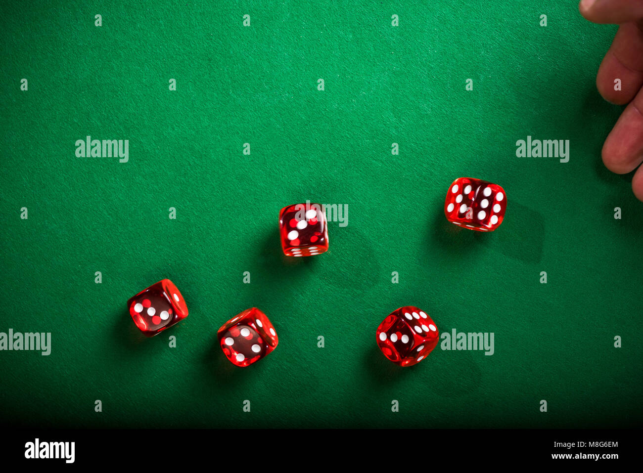 Rolling red dices Stock Photo - Alamy