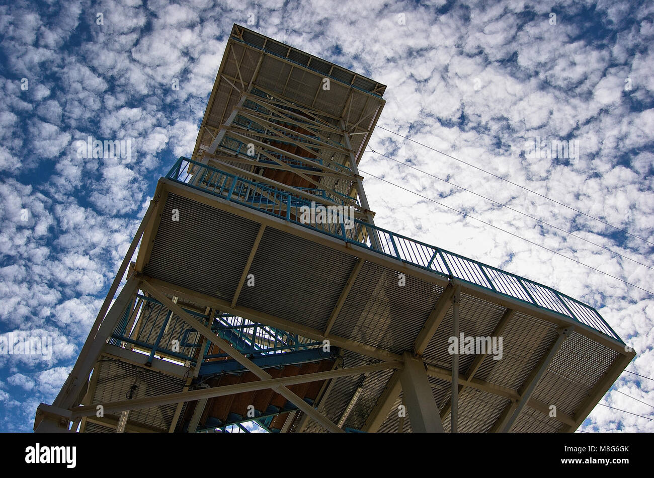 Looking up at a metal platform used for zip line Stock Photo - Alamy