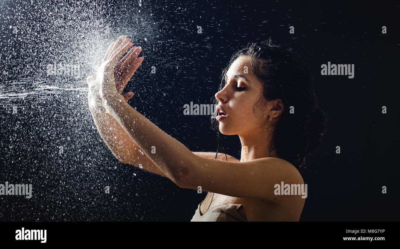 young girl portrait and splashing water in her face. beautiful female ...