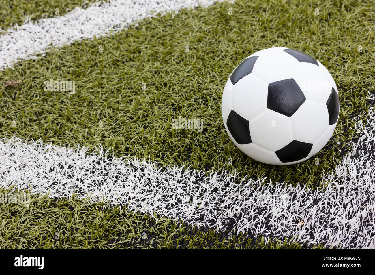 Soccer ball on green field Stock Photo - Alamy