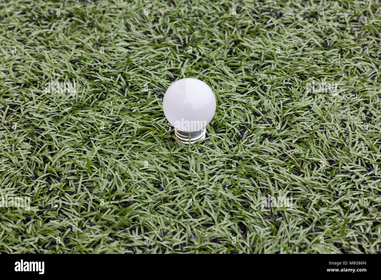 Lamp in green grass background on morning Stock Photo - Alamy